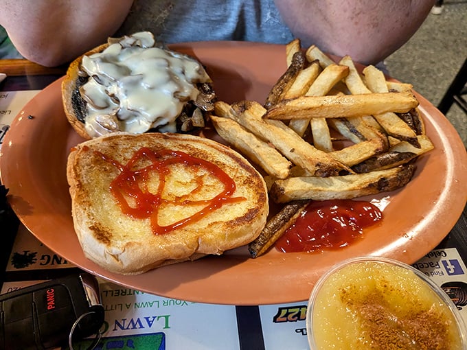 This isn't just a mushroom Swiss burger—it's a masterclass in comfort food architecture, with those onion rings standing guard like delicious sentinels.