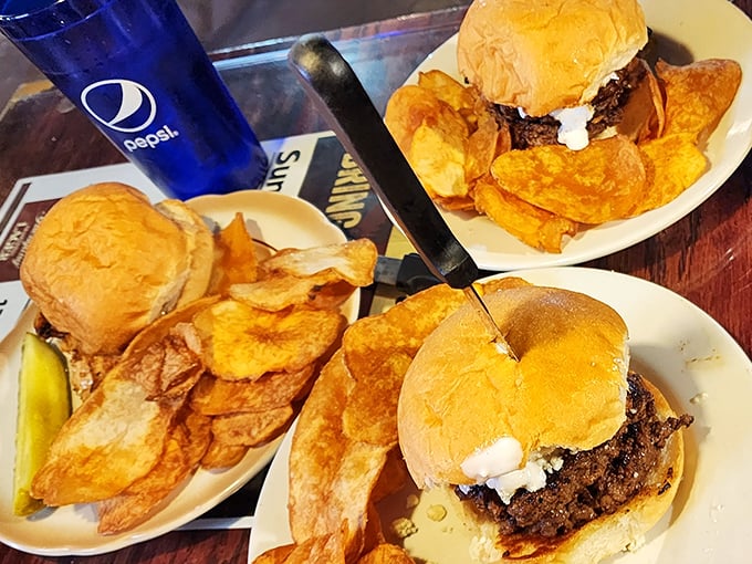 The holy trinity of burger perfection: juicy patties, golden buns, and homemade chips that shatter with a satisfying crunch.