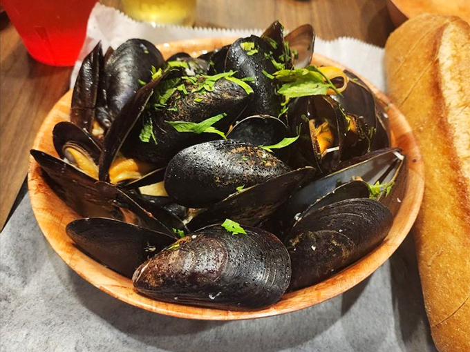 These mussels aren't just seafood; they're little black pearls of oceanic flavor, swimming in a broth you'll want to sop up with every available bread.