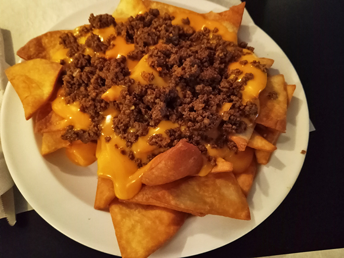 These nachos arrive like a delicious avalanche of cheese and toppings that would make any sports bar jealous.