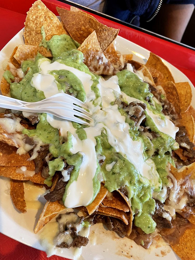 Nachos aren't just a snack here&mdash;they're a full-fledged meal with layers of chips, meat, cheese, and guacamole creating a mountain of deliciousness.