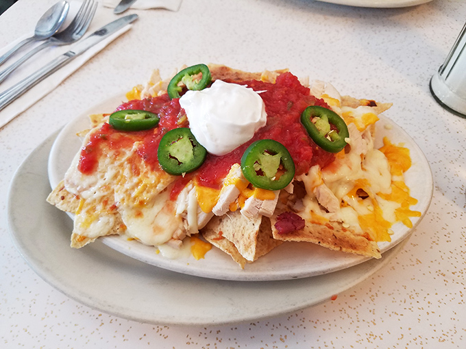 Nachos that understand the importance of proper cheese-to-topping ratio&mdash;a architectural marvel topped with jalape&ntilde;os for those who like their memories spicy.