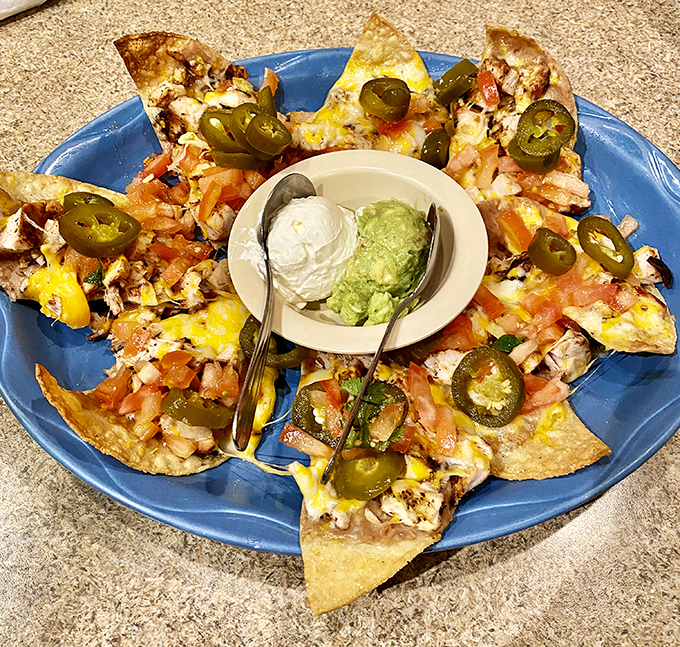 Nachos arranged in a perfect circle, like a Mexican sun with jalape&ntilde;o rays. That central duo of sour cream and guacamole is calling your name.
