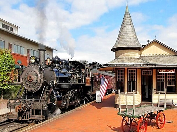 All aboard nostalgia! The New Hope Railroad's vintage steam engine puffs majestically beside a perfectly preserved station, ready to transport you through time.