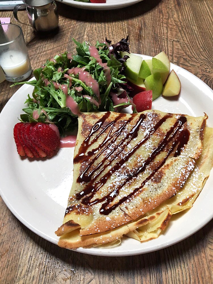 A crepe drizzled with chocolate, surrounded by fresh fruit&mdash;proof that sometimes the simplest pleasures are the most profound. Dessert or breakfast? Yes.