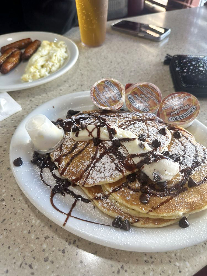 Chocolate chip pancakes topped with whipped cream and chocolate drizzle. Dessert masquerading as breakfast&mdash;the best kind of morning deception.