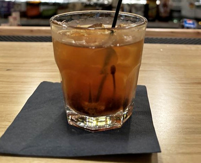 An Old Fashioned that sits patiently on its throne of slate, waiting to complement your steak with whiskey wisdom.