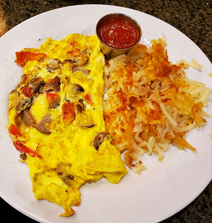 This omelet doesn't just contain mushrooms and peppers&mdash;it celebrates them in a fluffy yellow embrace alongside crispy hash browns.