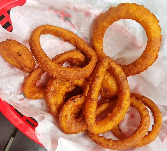 These onion rings aren't just side dishes &ndash; they're golden halos of perfectly fried goodness that deserve their own moment of silent appreciation.
