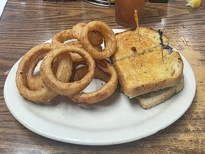 Onion rings with the perfect crunch-to-softness ratio, paired with grilled cheese—proof that simplicity, when done right, is culinary genius.