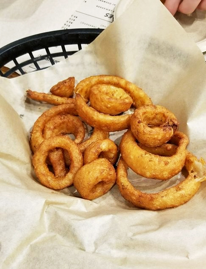 Onion rings with architectural integrity&mdash;golden hoops of beer-battered perfection that maintain their structure while surrendering to your bite.
