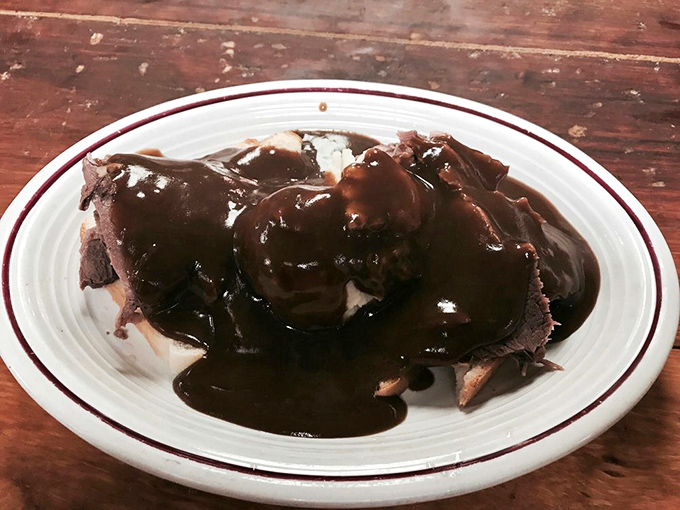 Open-faced hot beef sandwich swimming in gravy so good you'll want to dive in after it. Comfort food that hugs your soul. 
