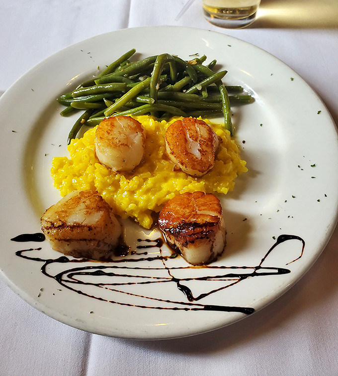 These scallops, perfectly seared and perched atop sunshine-yellow risotto, might make you temporarily forget you're in a steakhouse.