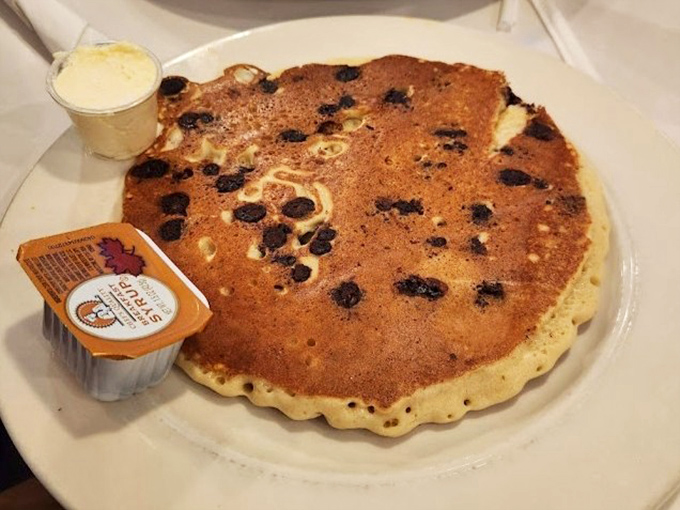 The blueberry pancake arrives like a fluffy disc of joy, studded with berries that burst with each bite&mdash;breakfast or dessert? Why choose?