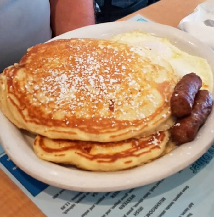 Pancakes stacked tall and fluffy, the kind that make you understand why breakfast is called the most important meal.