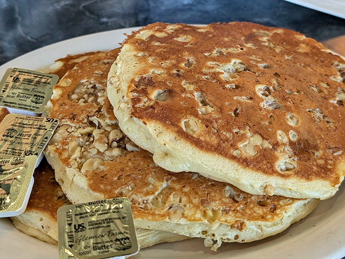 Pancakes so fluffy they practically hover above the plate. Those butter pats are melting with anticipation.