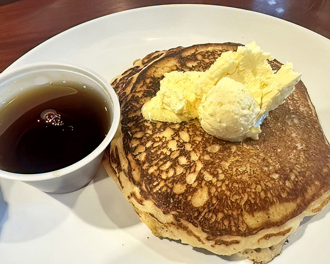 Pancakes so perfectly golden they belong in Fort Knox, topped with butter melting like California sunshine.