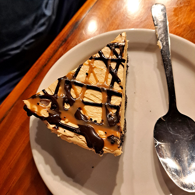 This slice of peanut butter pie with chocolate drizzle isn't just dessert; it's therapy that costs less than a session with your therapist.