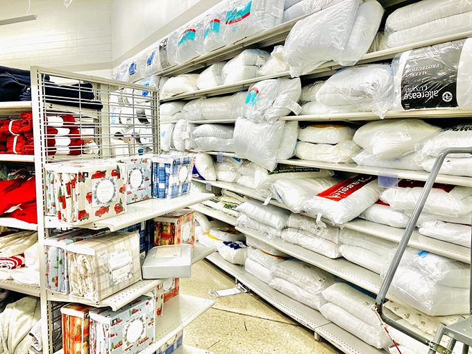 Bedding that dreams are made of—stacks of pillows and comforters promising cloud-like comfort without the sky-high department store prices.