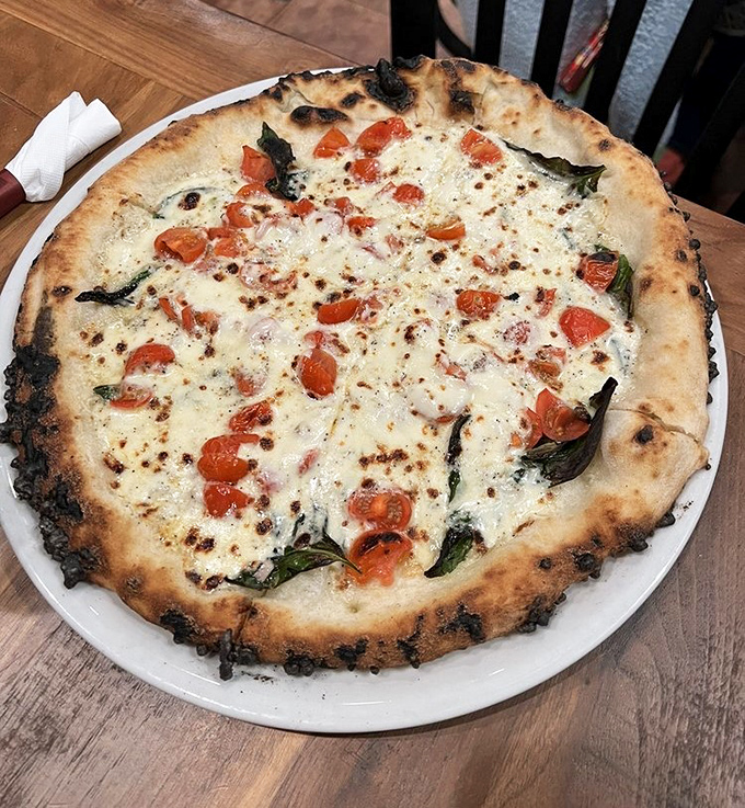 A white pizza that proves sometimes what you leave off is as important as what you put on. Those fresh tomatoes are little flavor bombs.