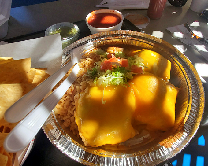 Pollo fundido swimming in cheese like it's taking the world's most delicious bath.