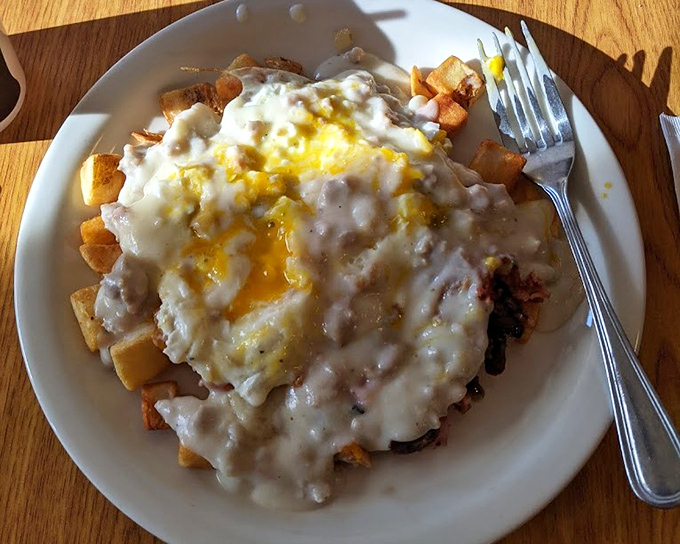 Biscuits drowning happily in a sea of sausage gravy. The kind of breakfast that requires a nap afterward, but you'll regret nothing.