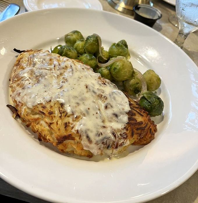 The potato-crusted grouper wears its golden jacket proudly alongside Brussels sprouts—proof that Florida fish can dress up without being pretentious.
