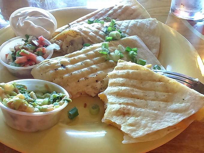 A quesadilla that doesn't mess around, served with the holy trinity of accompaniments: sour cream, salsa, and guacamole for customized dipping pleasure.