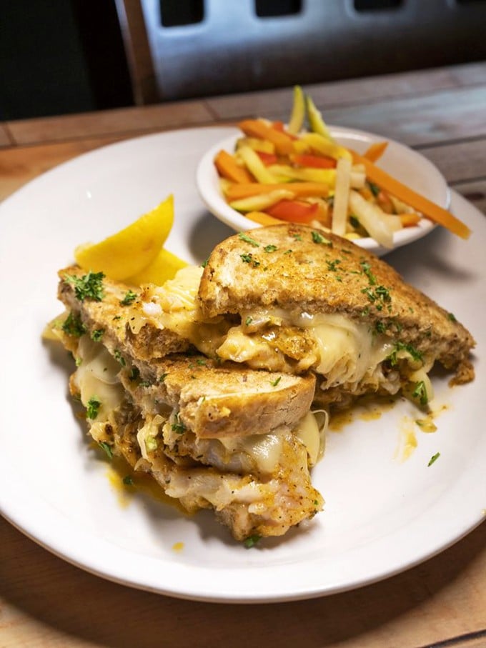 A sandwich so packed with seafood and melty cheese it requires a strategy to eat. Worth every napkin.