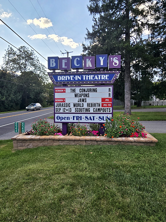 The roadside marquee proudly announces tonight's features, a glowing invitation to pull over and stay awhile.
