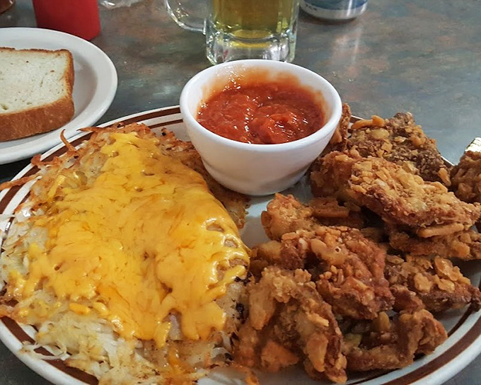 Rocky Mountain Oysters for the brave, hash browns smothered in cheese for everyone else&mdash;this plate screams "Nebraska adventure."