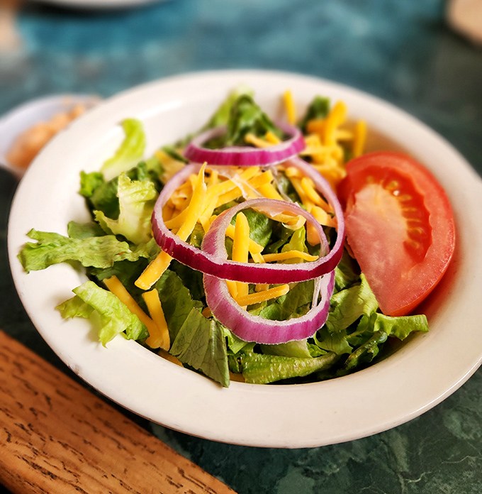 Even the side salad gets special attention &ndash; crisp greens, vibrant vegetables, and a simplicity that respects good ingredients rather than drowning them.