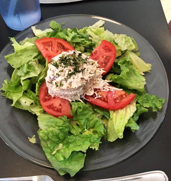 A salad that actually makes you excited about eating greens. That tuna scoop in the middle? The crown jewel of a leafy kingdom.