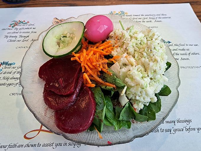 A colorful salad plate featuring pickled beets and chicken salad. The placemat prayers remind you this is authentic Amish Country dining at its finest.
