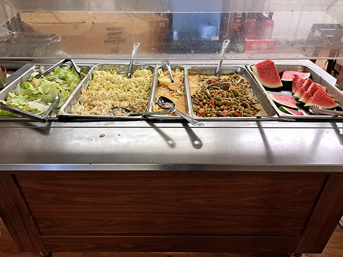 Fresh salad options and watermelon slices offer the perfect counterpoint to the heartier fare, proving Southern cooking knows its balance.