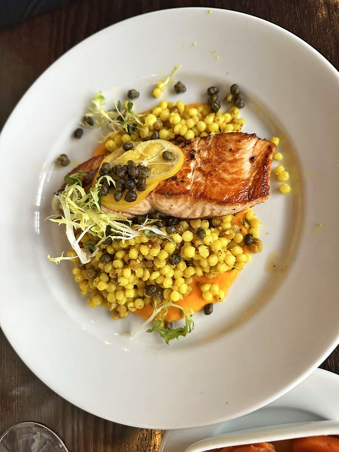 Perfectly seared salmon atop golden pearls of couscous and capers&mdash;ocean meets farmland in a dish that practically demands a glass of white wine.
