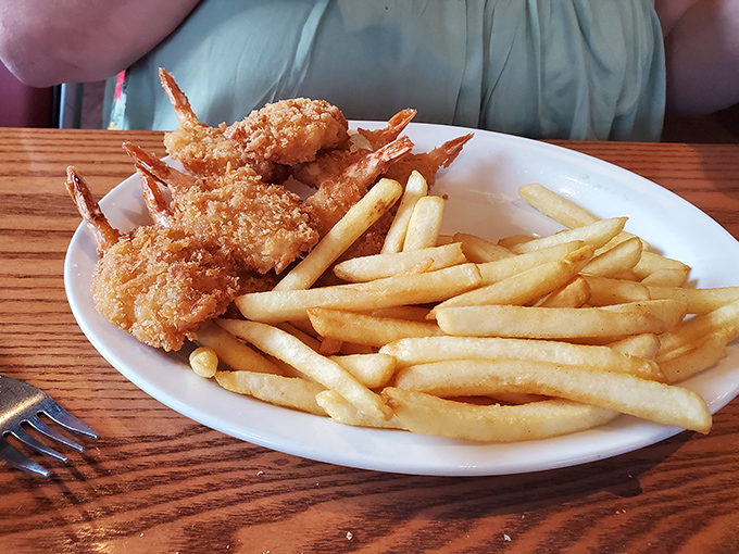 Golden-fried shrimp that crunch like autumn leaves, paired with fries so perfectly cooked they deserve their own appreciation society.