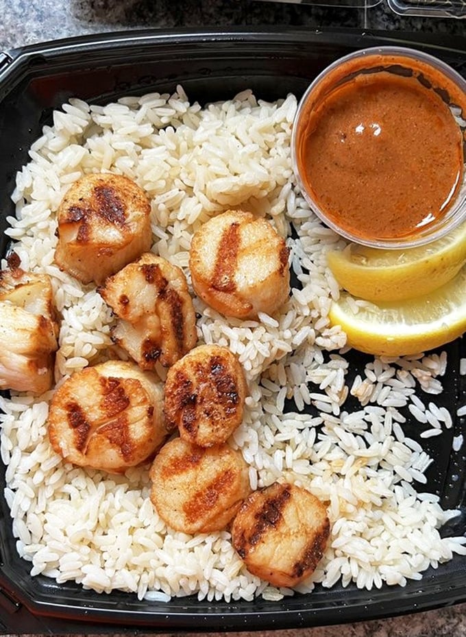Scallops seared to golden perfection, arranged like edible poker chips on a bed of rice &ndash; except in this game, everyone's a winner.