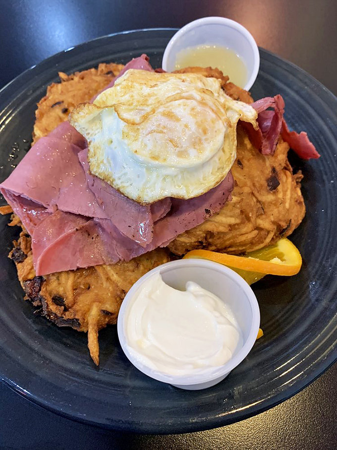 The Schmoozer plate showcases sweet potato hash browns topped with ham and a perfectly fried egg&mdash;a tower of breakfast glory that demands to be photographed.
