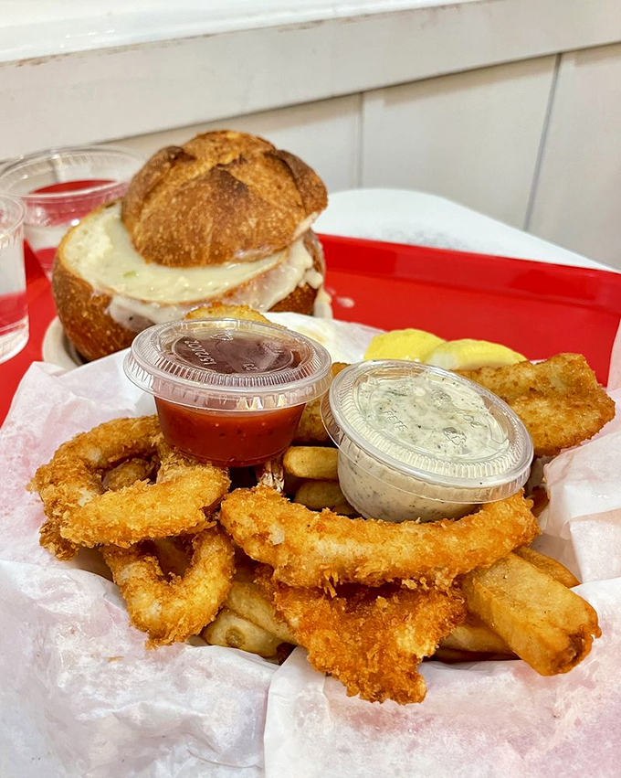 A seafood platter that doubles as a love letter to the ocean &ndash; crispy onion rings, tender seafood, and dipping sauces galore.