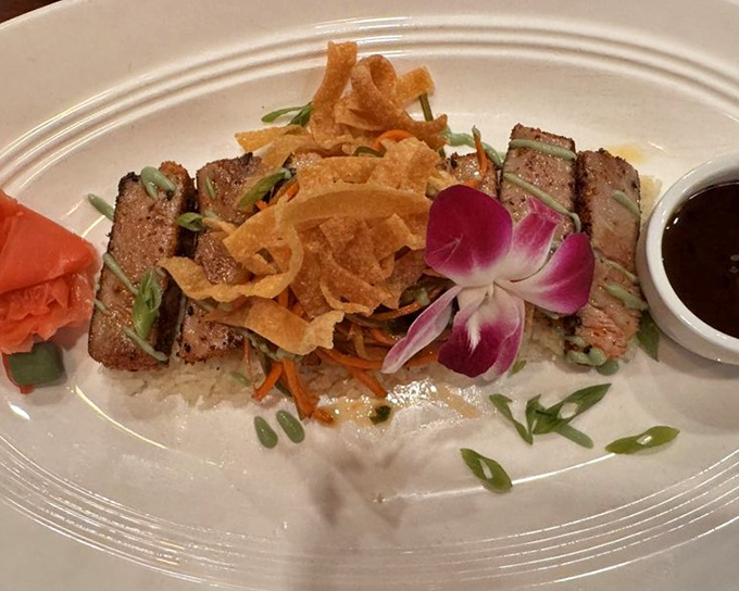 Seared ahi tuna slices fanned out like a deck of delicious cards. Crispy onion straws add texture to this ocean-fresh masterpiece.