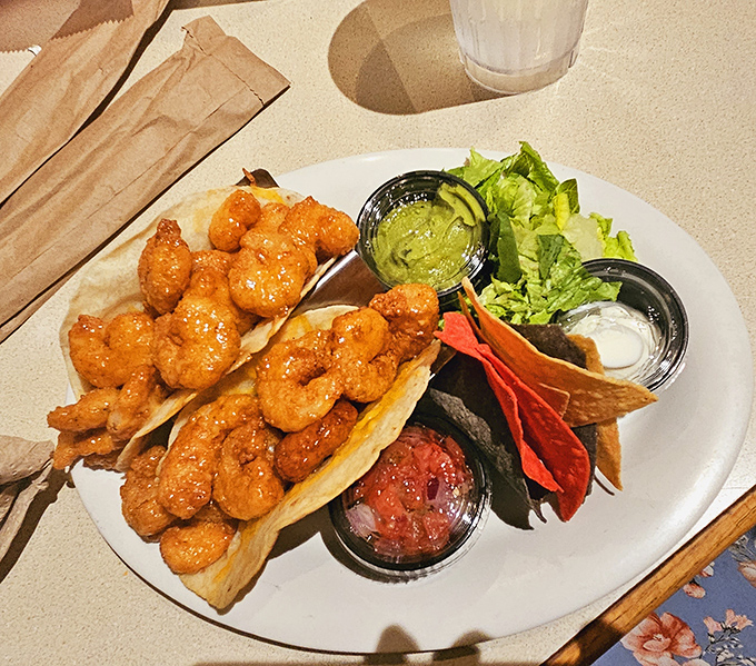 Tacos reimagined through Florida's coastal lens—crispy shrimp dressed in vivid sauces nestled in soft shells. Tuesday has nothing to do with it.