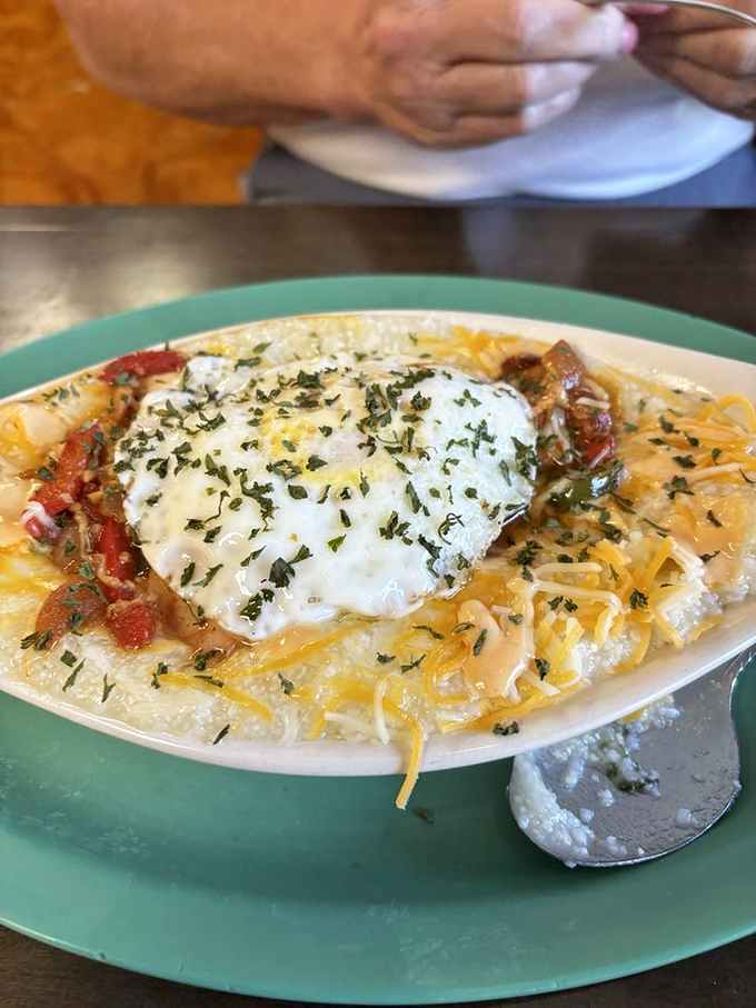 Shrimp and grits get the royal treatment with a crown of melted cheese and fresh herbs&mdash;Southern coastal tradition meets mountain hospitality.