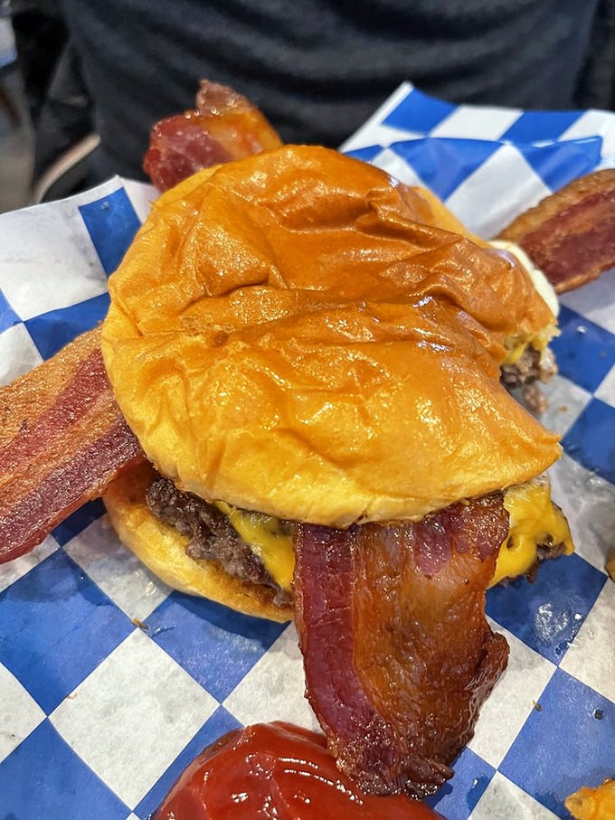 This isn't just a breakfast sandwich &ndash; it's a monument to morning excess with bacon dramatically extending beyond the bun's borders.