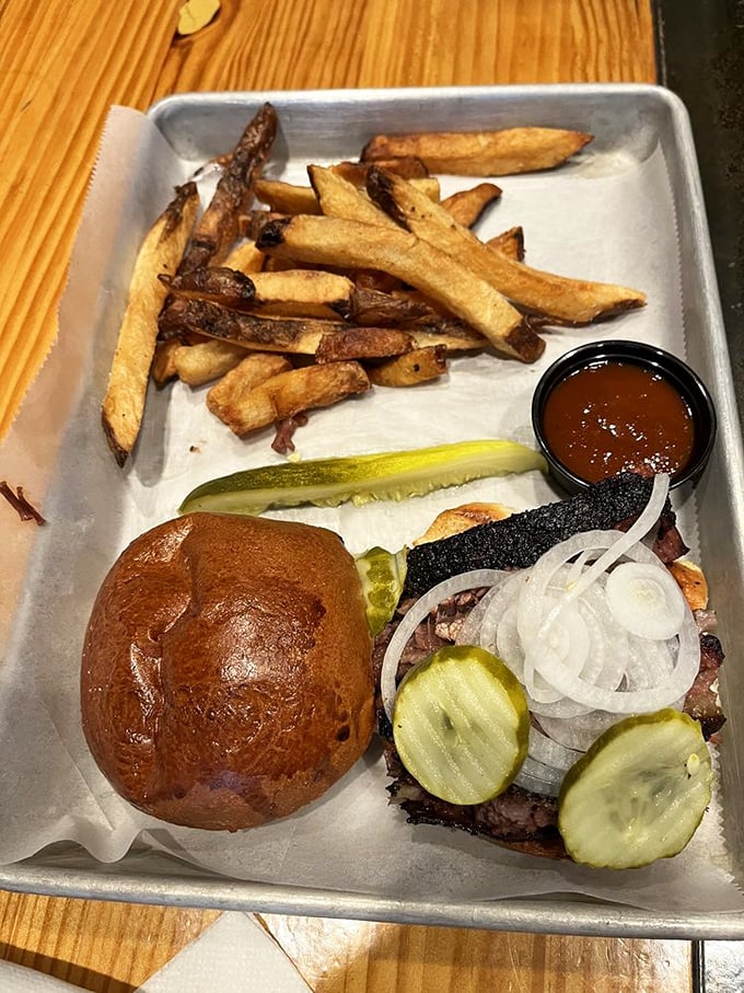 A sandwich that demands to be photographed before eaten, with house-smoked meat, pickles, and a bun that's achieved golden perfection.