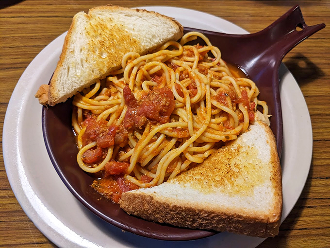 Spaghetti that doesn't need a passport to transport you to comfort food nirvana, flanked by garlic toast that means business.