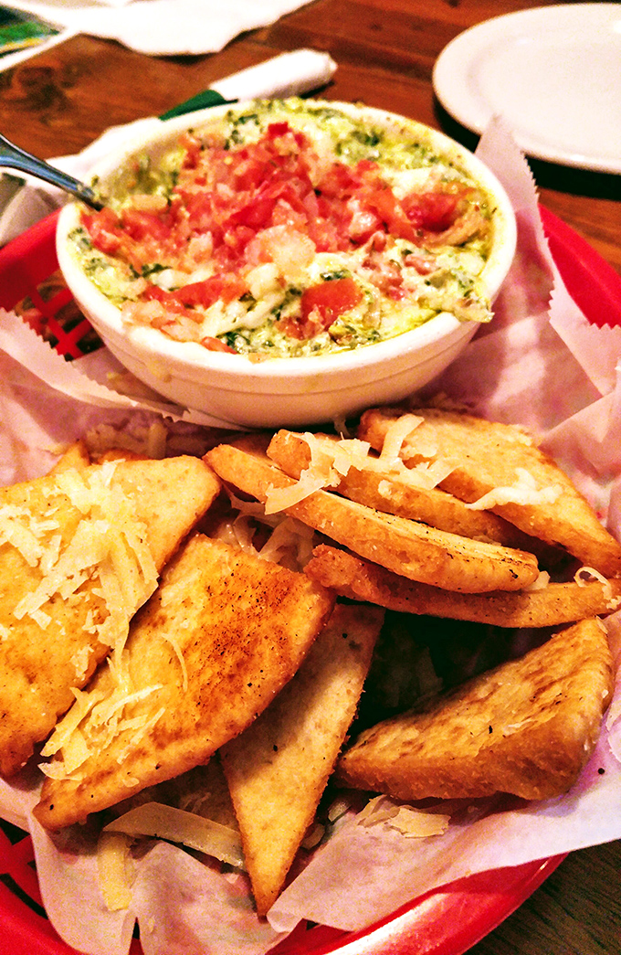Spinach artichoke dip with enough cheese pull to qualify as an Olympic sport, served with garlic bread that's ready for its supporting role.