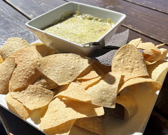 This isn't just spinach artichoke dip&mdash;it's a bubbling cauldron of cheese with crispy tortilla chips standing by, ready for their delicious destiny.