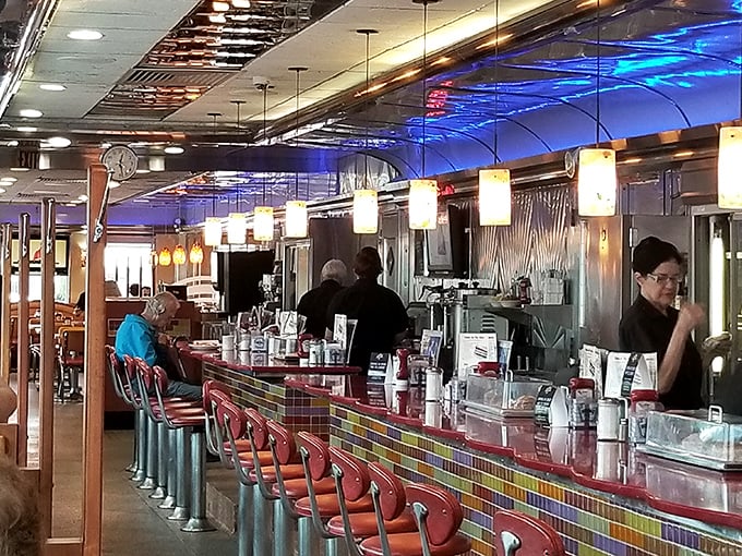 The counter view offers dinner and a show as short-order cooks perform their breakfast ballet with practiced precision.