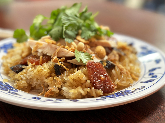 Sticky rice that's traveled through centuries of tradition to land on your plate, topped with savory morsels that make each bite a discovery.